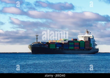 Modern grey container ship moving in still water Stock Photo - Alamy