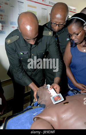 Military medical personnel perform intubation exercises on a METIman ...