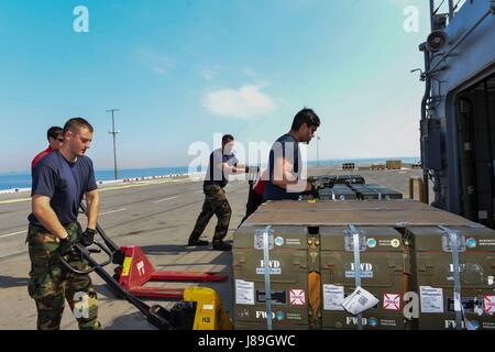 Sailors load a forklift on the flight deck of the aircraft carrier USS ...