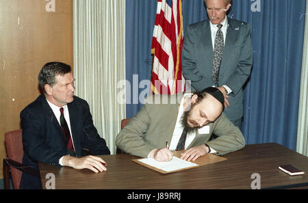 men sitting signing papers Stock Photo - Alamy