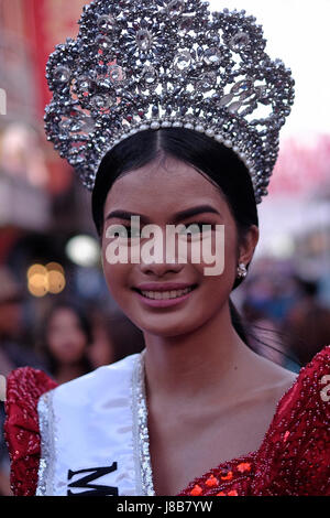 A Filipino Woman Takes Part In A Street Procession During The Ati ...