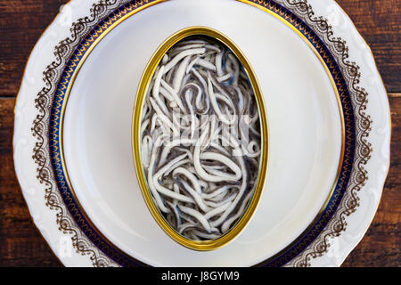 Canister of canned elvers on a elegant dish Stock Photo - Alamy