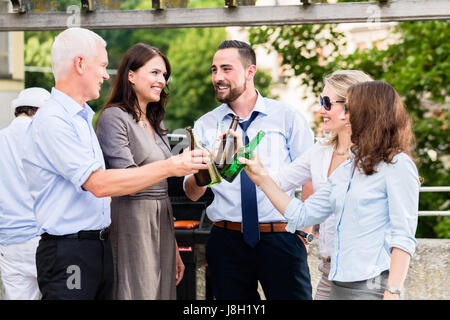Office colleagues drinking beer after work Stock Photo - Alamy
