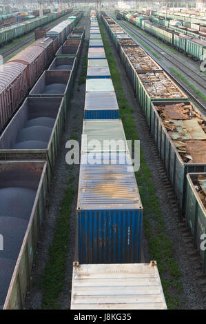 long trains with industrial goods stand on the rails Stock Photo - Alamy