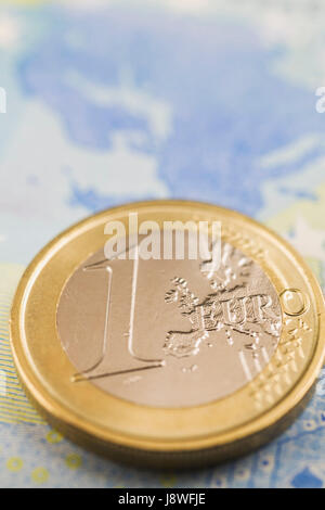 Euro coin on top of twenty and ten Euros denomination paper currency ...
