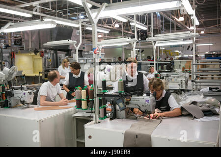 Workers at the Aston Martin factory at Gaydon in Warwickshire UK spray ...