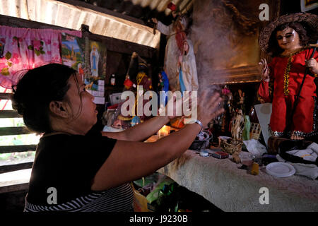 A Mananambal spiritual healer performs a healing ritual on a young ...