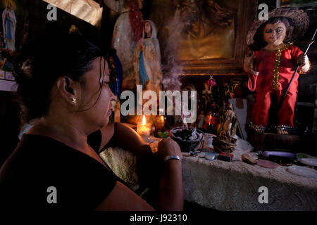 A Mananambal spiritual healer performs a healing ritual on a young ...
