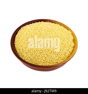 plate with raw cereal millet on a wooden background. preparation of a ...