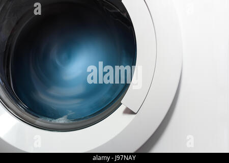 Front view and portion of the porthole of the washing machine during ...