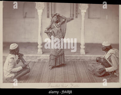 Nautch girl dancing, while two men play a string instrument and a drum ...