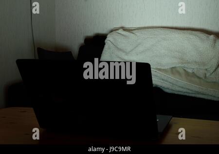 Computer screen illuminating a dark room at night Stock Photo - Alamy