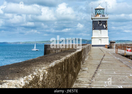 View of the lighthouse at the end of Holyhead breakwater on Anglesey ...