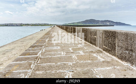 Perspective view along the breakwater at Holyhead on Anglesey Stock ...