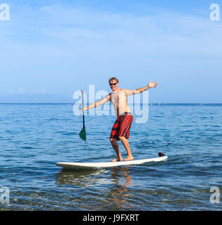 a man while stand-up-padding on the sea Stock Photo - Alamy