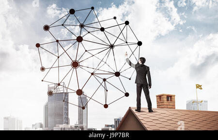 Businessman on house roof presenting networking and connection c Stock ...