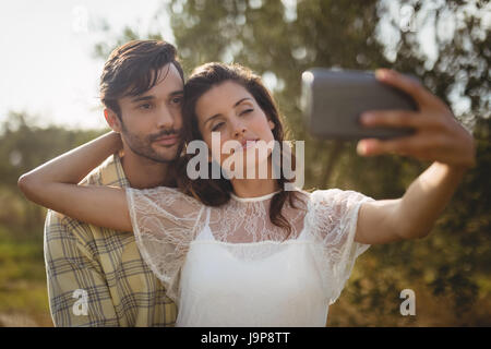 A beautiful shot of a Hispanic man with a phone showing emotions in ...