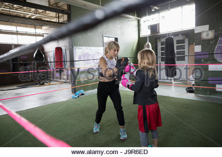 Daughter training mother for boxing in park Stock Photo - Alamy