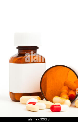 Bottle of medication knocked over against white background Stock Photo ...
