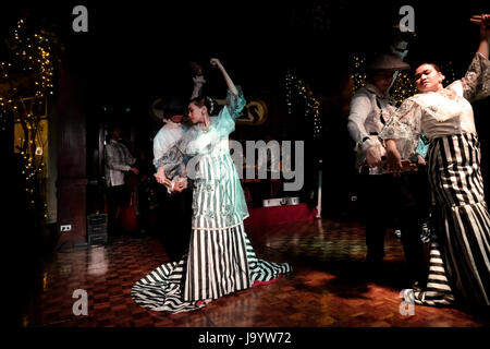 Filipino dancers performing traditional Philippine Carinosa folk dance ...