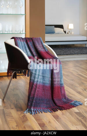 Throw draped over a chair Stock Photo - Alamy