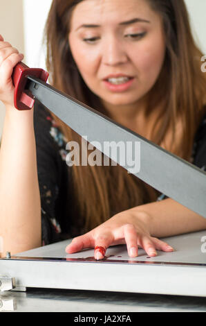 Woman using paper cutter, guillotine Stock Photo - Alamy