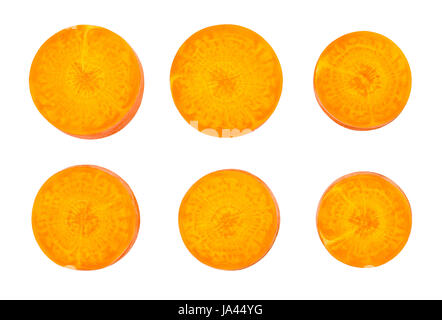 Group of sliced round orange carrot circles with fresh green leaf ...