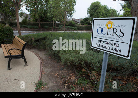A bench seat for smokers in a designated smoking area outside a office ...