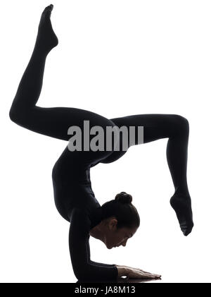 one woman contortionist practicing gymnastic yoga in silhouette on ...