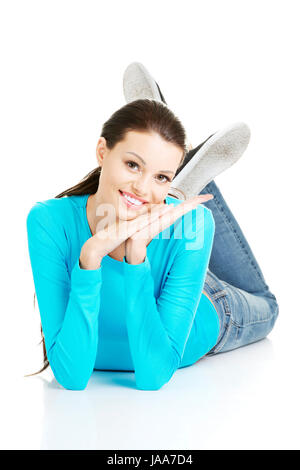 Photo of cheerful teenager lady lying floor alone home relax rest enjoy ...