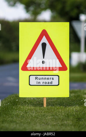 Warning sign, runners in road Stock Photo - Alamy