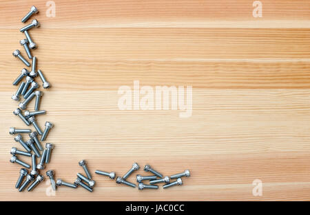 Socket head bolts as L-shape border on woodgrain background Stock Photo ...