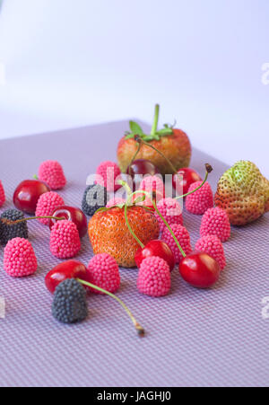 A group of strawberries, cherries and candies raspberry isolated on the ...