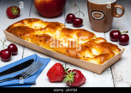 An elongated apple cake with coffee and fruit Stock Photo - Alamy