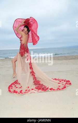 Bai Ling poses for a photoshoot wearing an oversized flowery red floppy ...