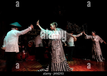 Filipino dancers performing traditional Philippine Carinosa folk dance ...