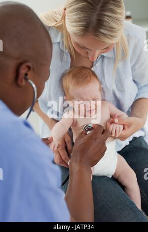 Doctor checking baby's heart beat Stock Photo - Alamy