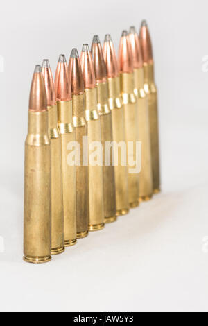 A few rifle bullets lined up in a row on white background Stock Photo ...