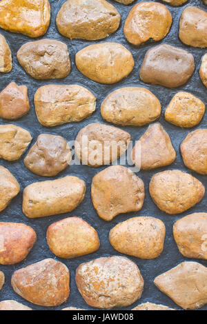 Textured stone wall in gaden at home, Thailand Stock Photo - Alamy