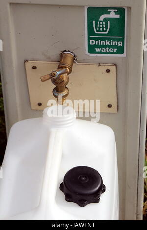 Filling a drinking water container at a campsite water and electricity ...