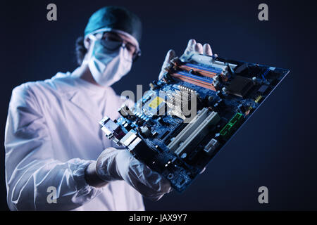 Computer engineer determines the main board problem Stock Photo - Alamy