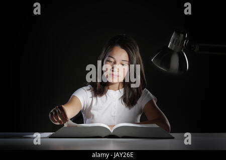 Studying late at night, with open book, candle, glasses and pen Stock ...