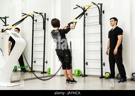 Concentrated man working out ems training with his coach Stock Photo ...