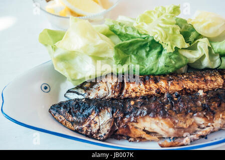 Grilled whole fish with citrus, and vegetable on rustic table Stock ...