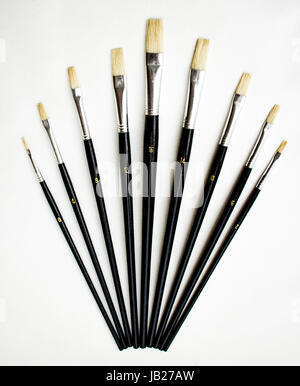 Different sized paint brushes isolated on white Stock Photo - Alamy