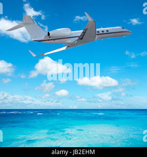 Private jet over the tropical sea Stock Photo - Alamy