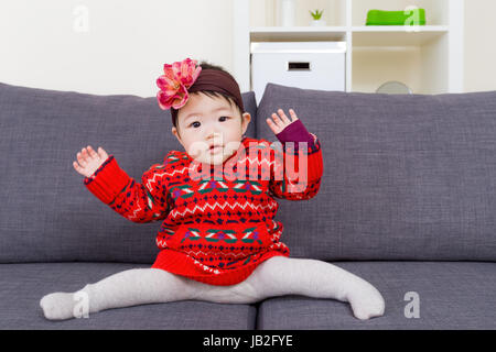 Baby girl doing legs splits on sofa Stock Photo - Alamy