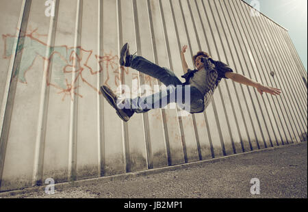 Young man falling from a building Stock Photo - Alamy