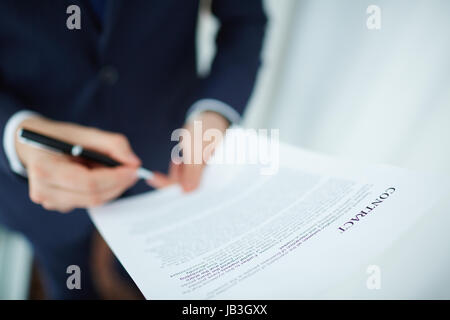 Image of contract being read and signed by businessman Stock Photo - Alamy