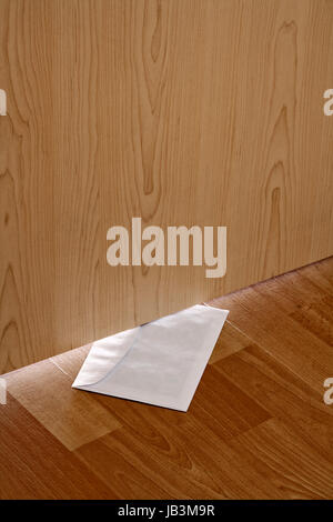 Envelope Slipped Under Door Stock Photo - Alamy